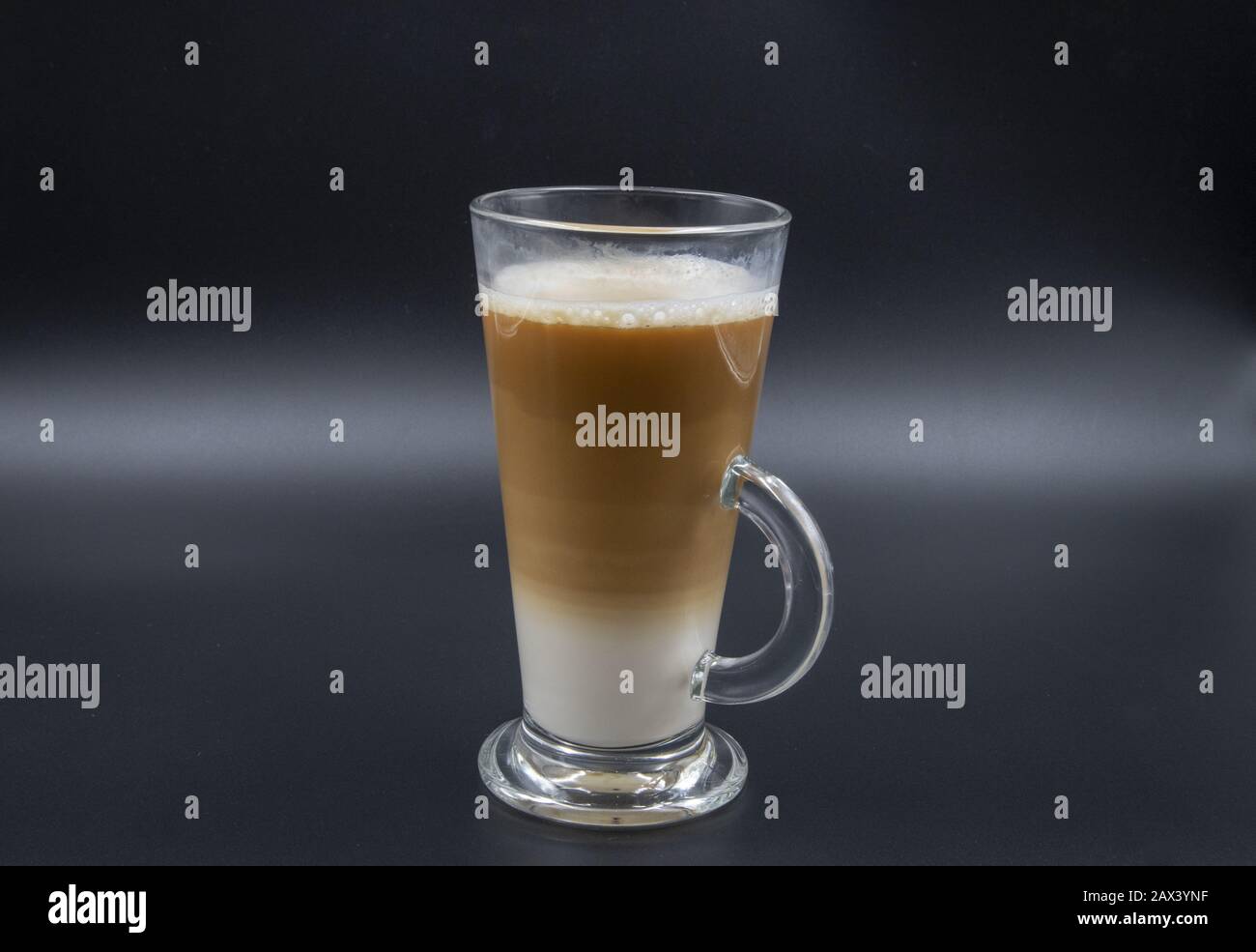 Studio shot of a three layered tea drink with black ombre background ...