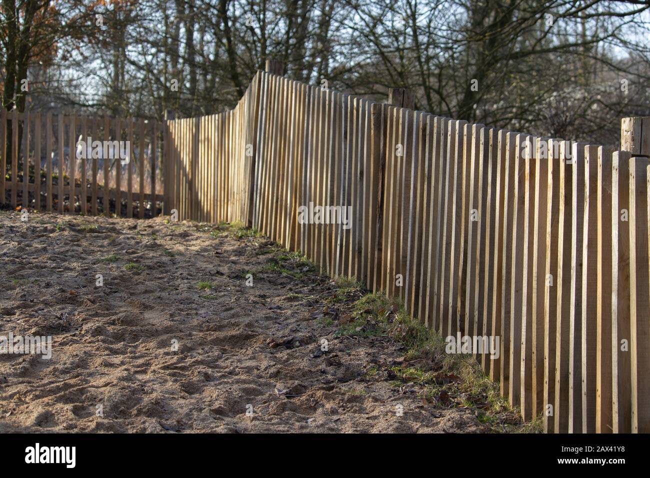 Closeup shot of a balk timber fence on a slope in a farm Stock Photo ...