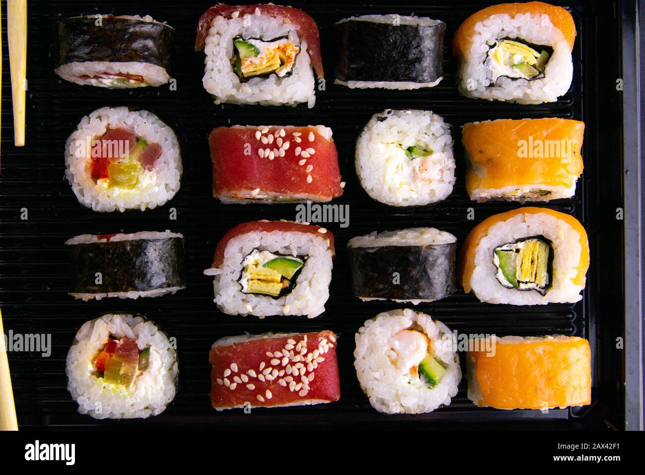 Different kinds of rolls stand on a black plate that stands on a black ...