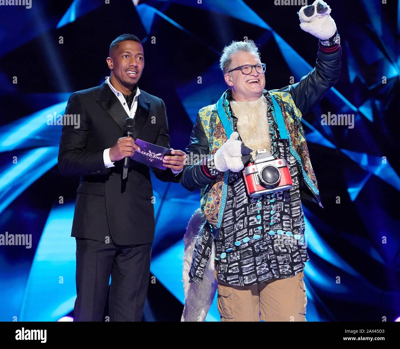 THE MASKED SINGER, from left: host Nick Cannon, Drew Carey (revealed as ...