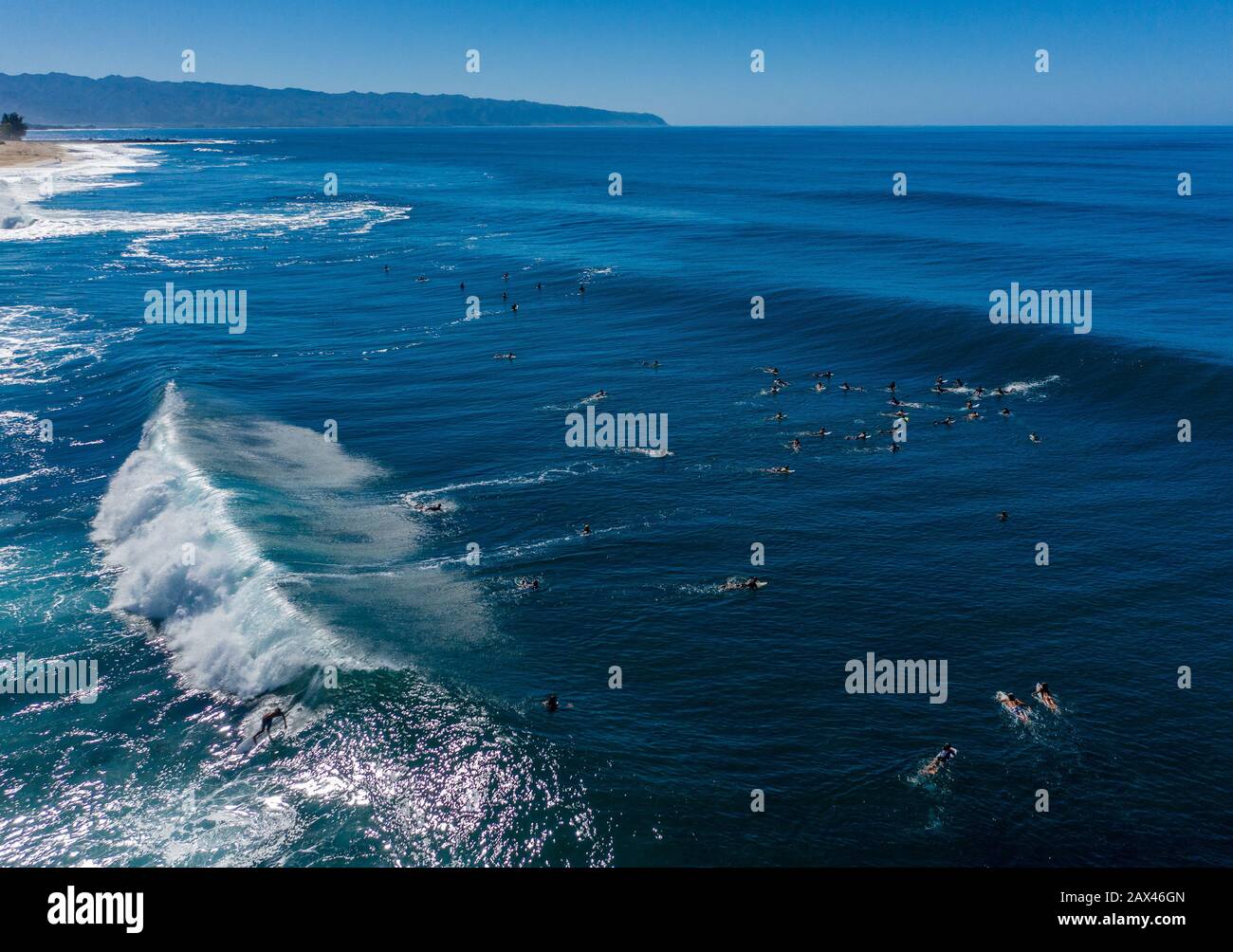 Surfers waiting for the big wave in the sea at Banzai Pipeline on north ...
