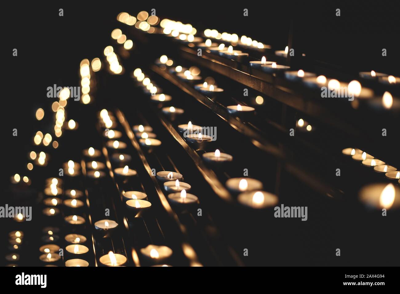 Dark background with many praying candle lights in the church Stock ...