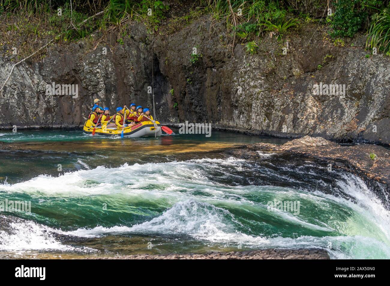 Group of white water rafters preparing to descend over the waterfall at ...