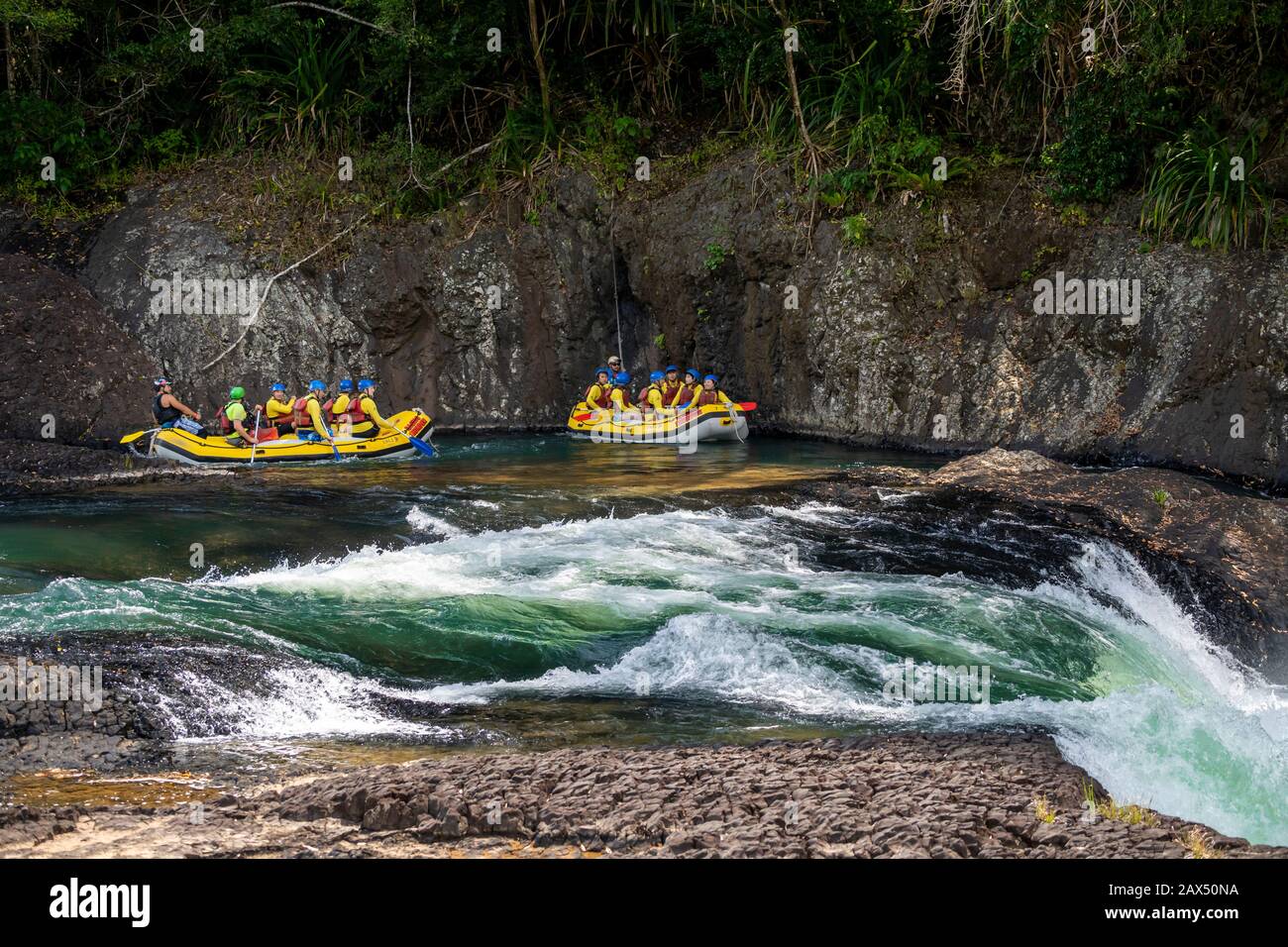 Group of white water rafters preparing to descend over the waterfall at ...