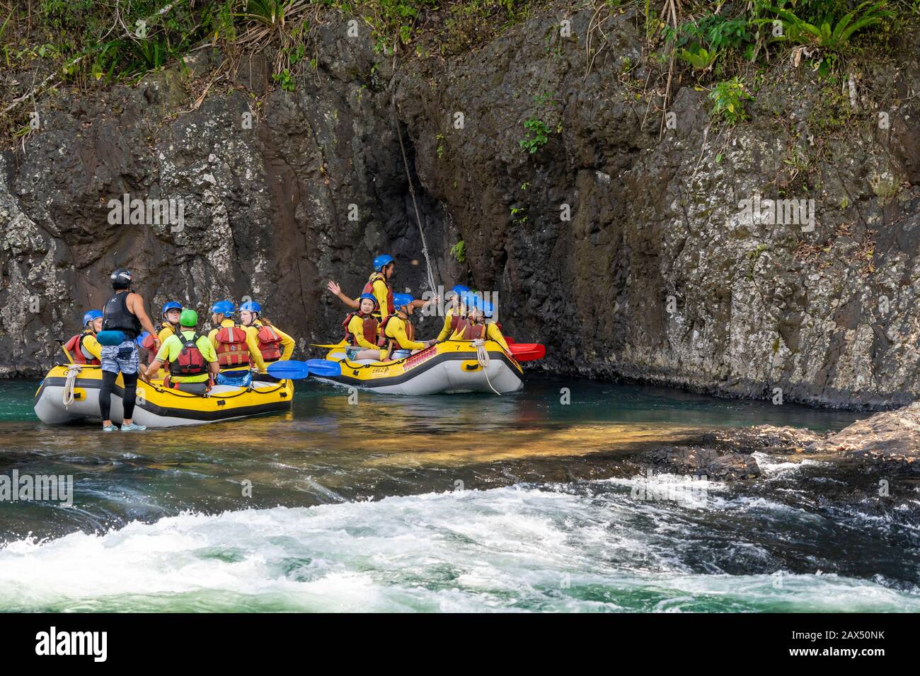Group of white water rafters preparing to descend over the waterfall at ...