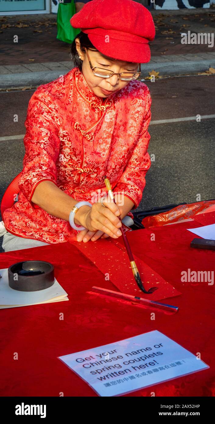 Chinese lady writing in Chinese characters names and spring couplets at ...