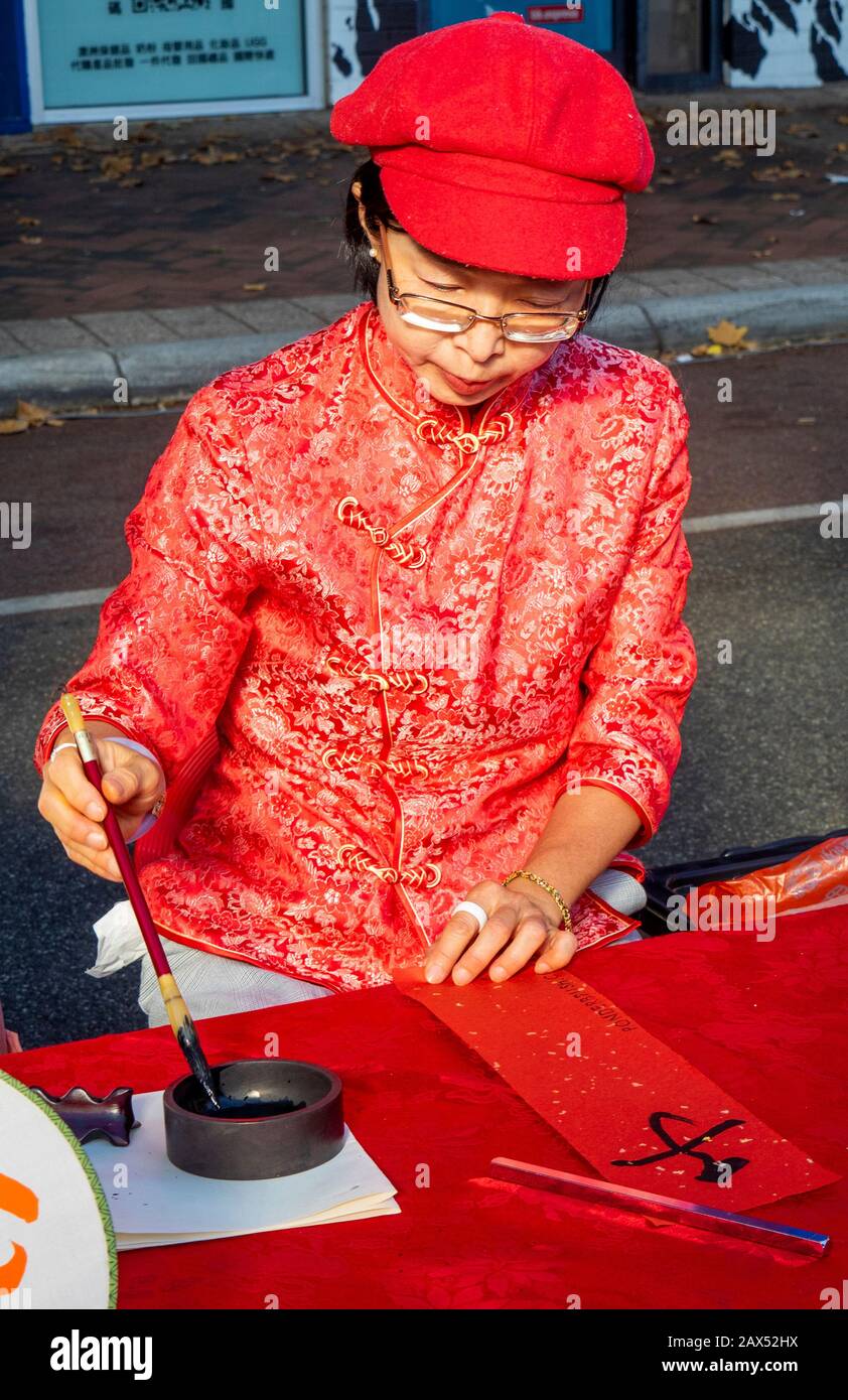Chinese lady writing in Chinese characters names and spring couplets at ...