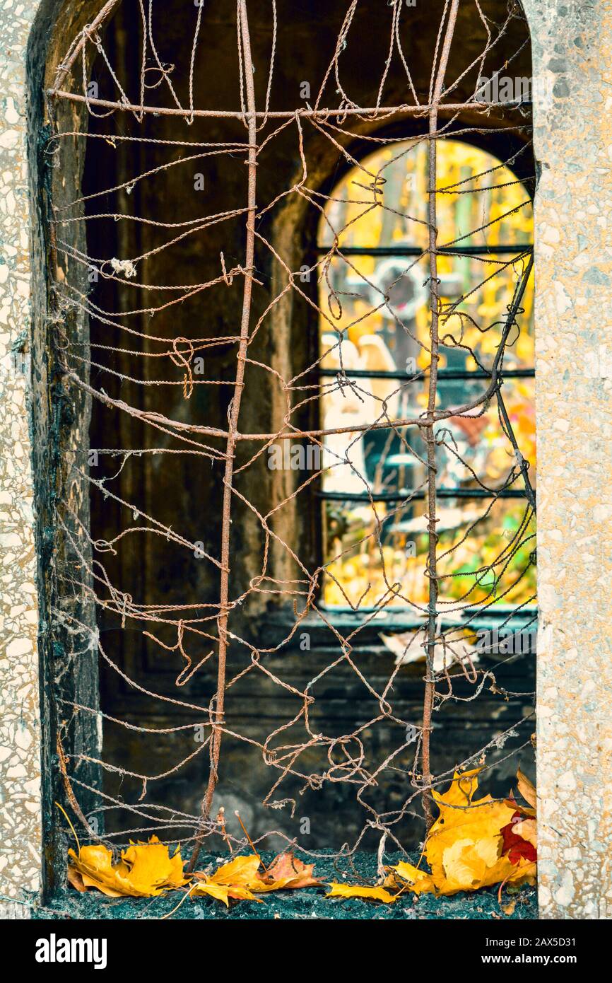 Window hole with lattice of old abandoned burial tomb crypt in public ...