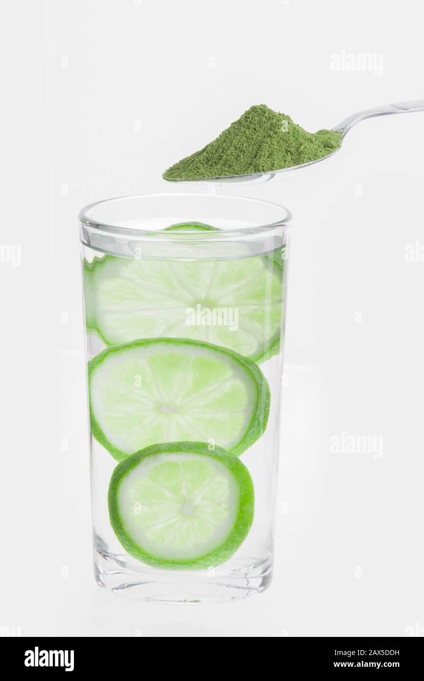 Moringa powder with lemon and glass with water isolated on white ...