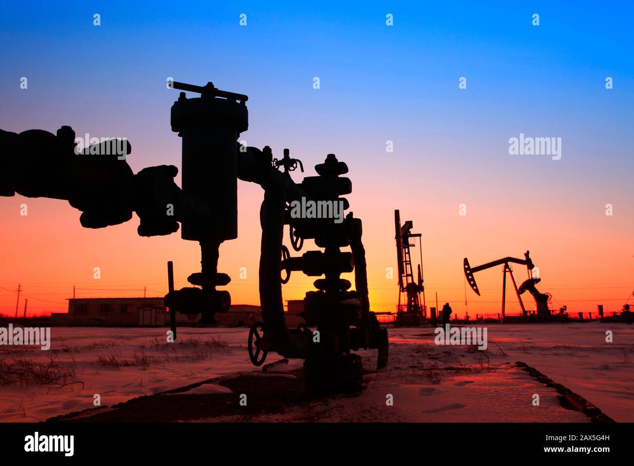 In the evening of oilfield pipeline silhouette Stock Photo - Alamy