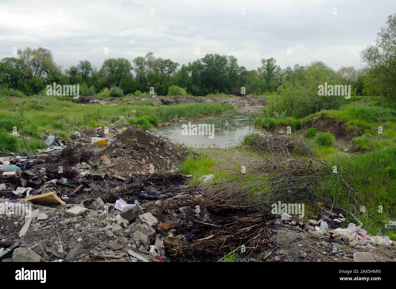 Polluted field with illegal trash dump Stock Photo - Alamy