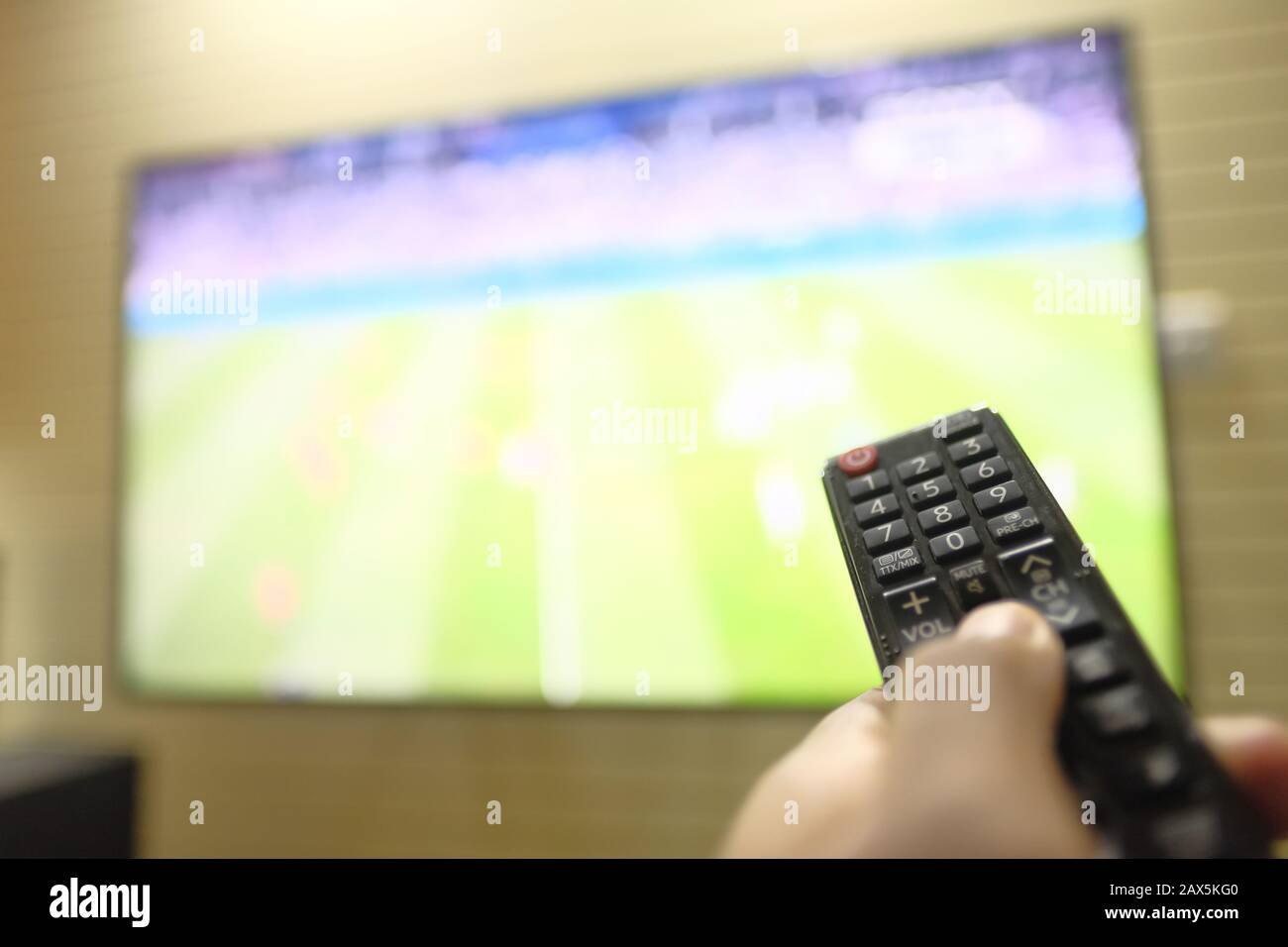 Close up of man hand with tv remote watching tv Stock Photo - Alamy