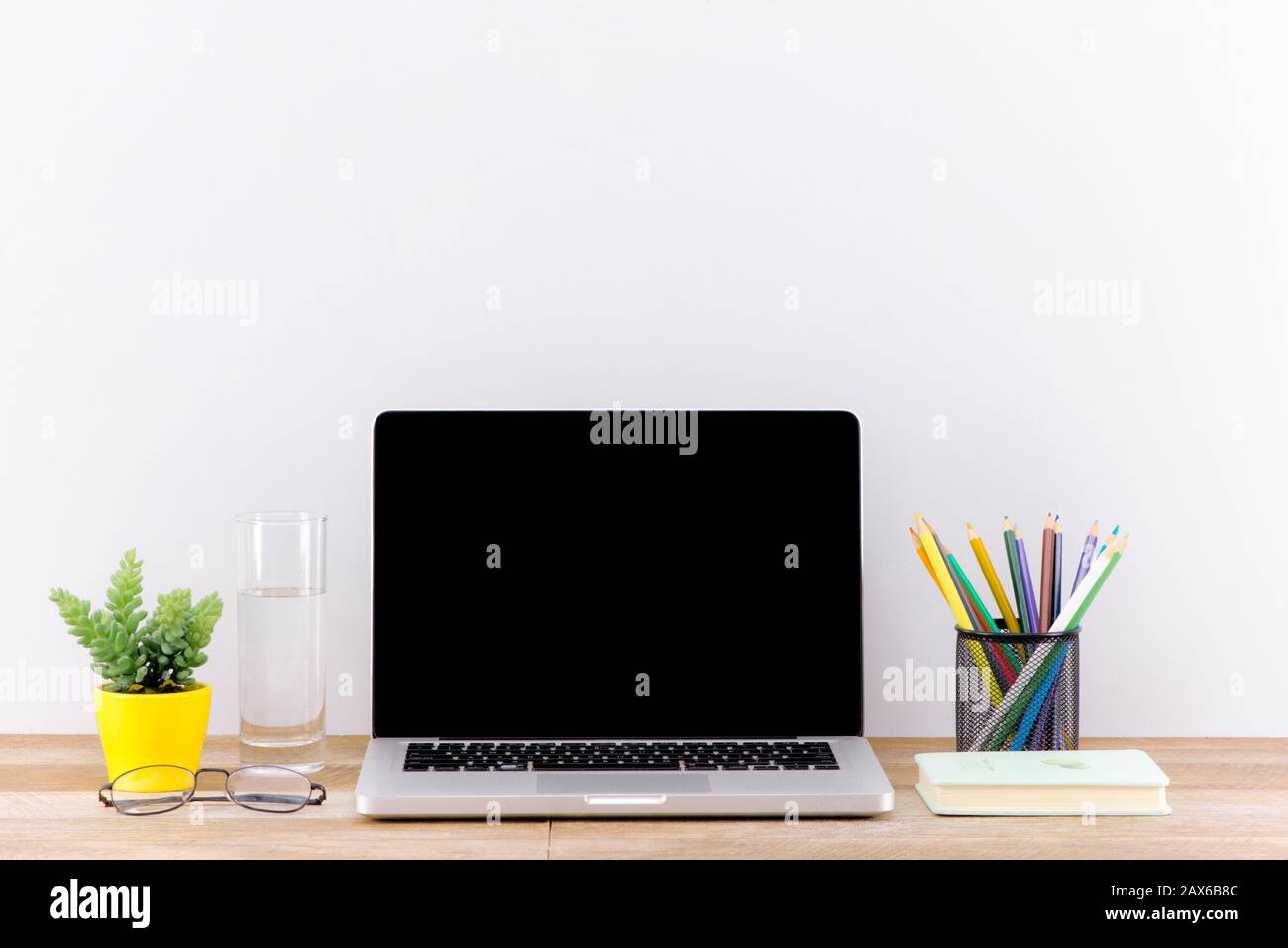 Mock up laptop, notebook on young student desk. Cyan pastel colors ...