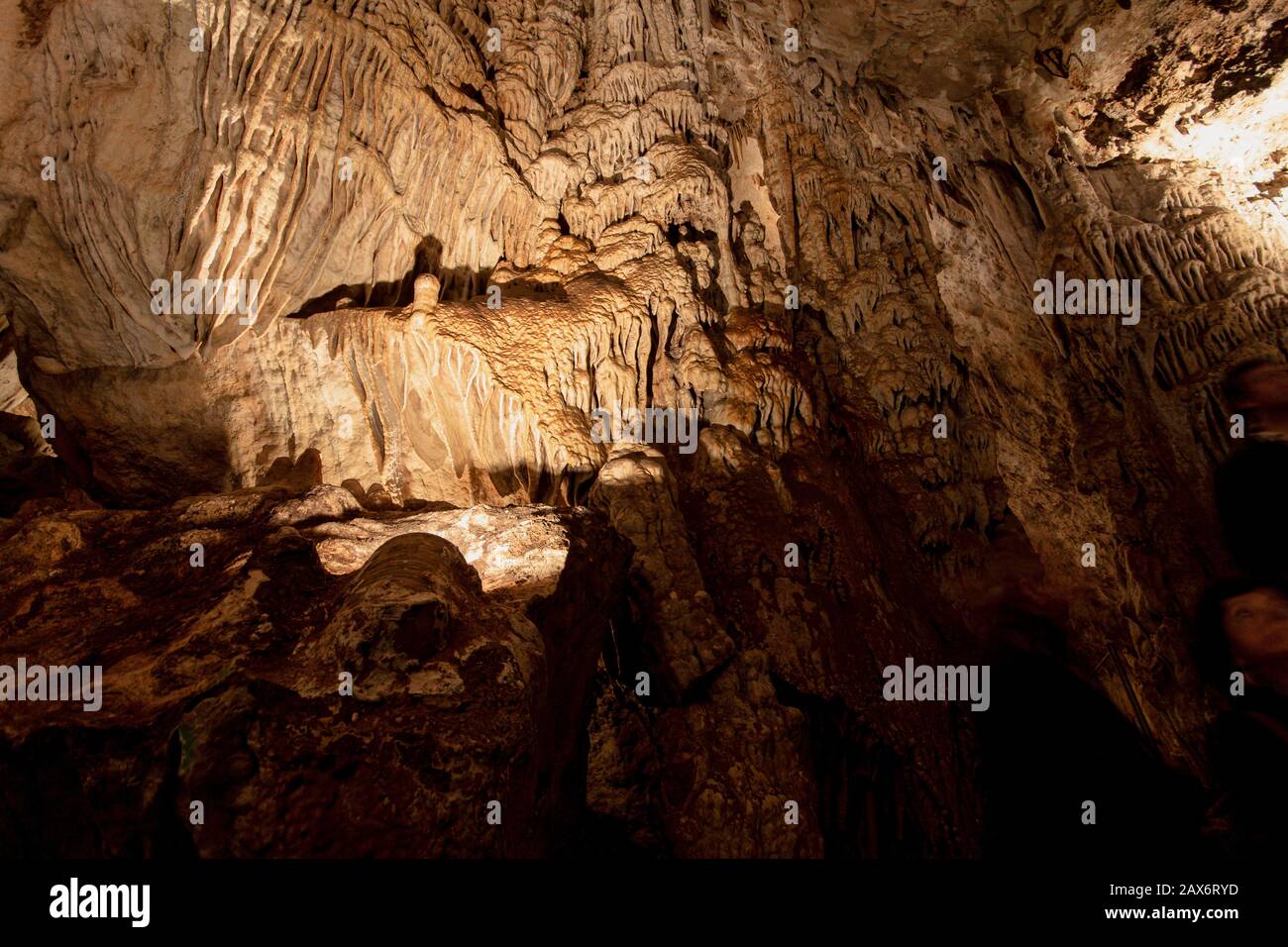Panorama of a cave wall with ancient stalactites, stalagmites and ...