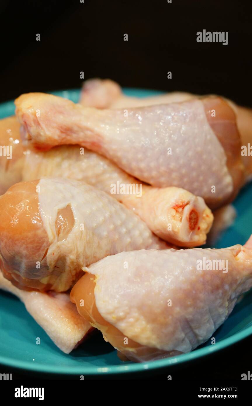 Chicken parts on top of each other in a bowl Stock Photo - Alamy