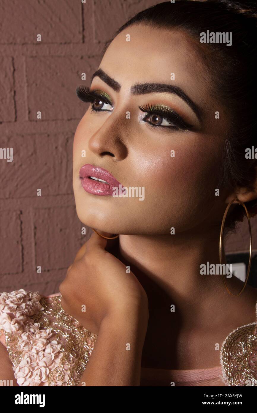 Model girl with elegant hairstyle. Face Close-up, looking sideways ...