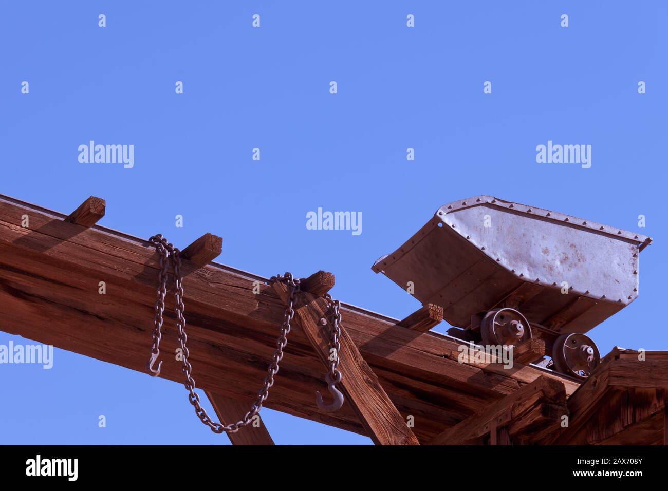 Iron cart riding through the wooden rails with a blue background Stock ...