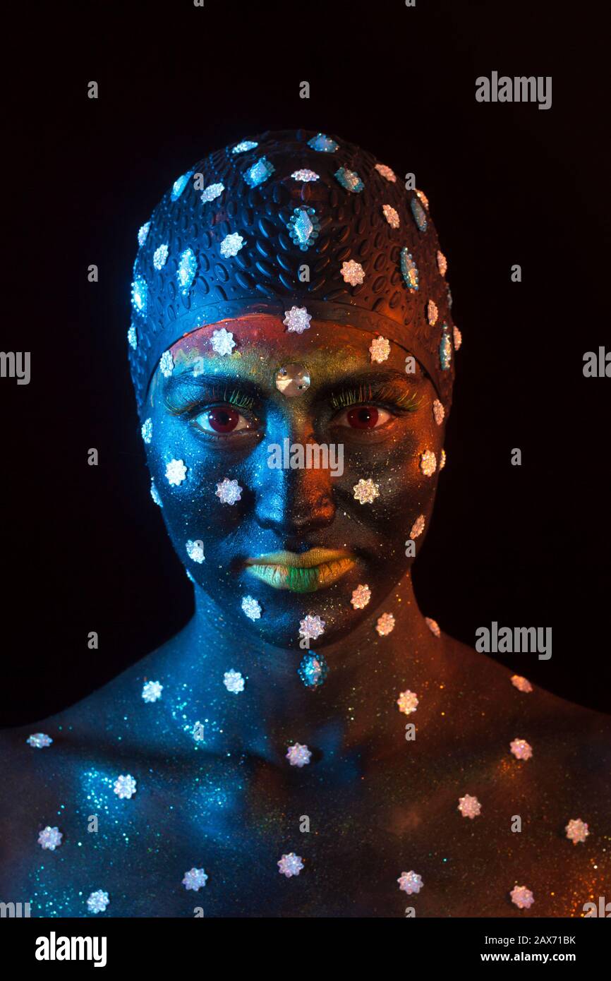 Fashion portrait of a dark-skinned girl with color make-up. Beauty face ...