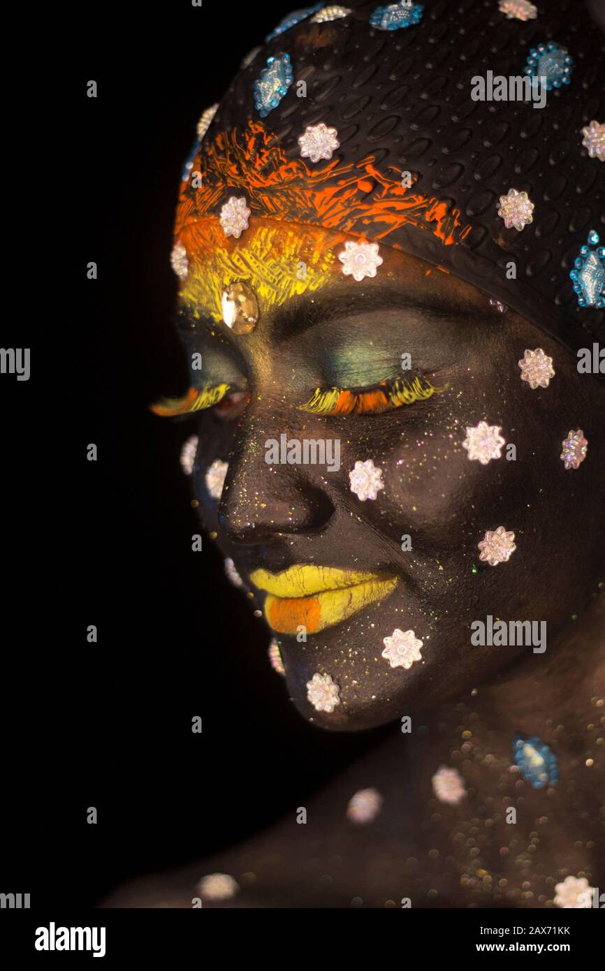 Fashion portrait of a dark-skinned girl with color make-up. Beauty face ...