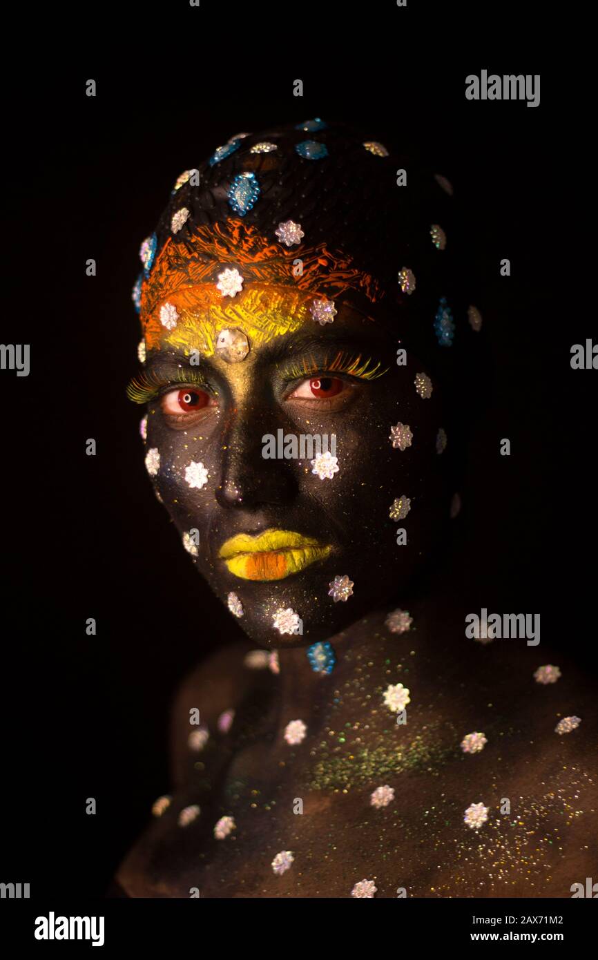 Fashion portrait of a dark-skinned girl with color make-up. Beauty face ...