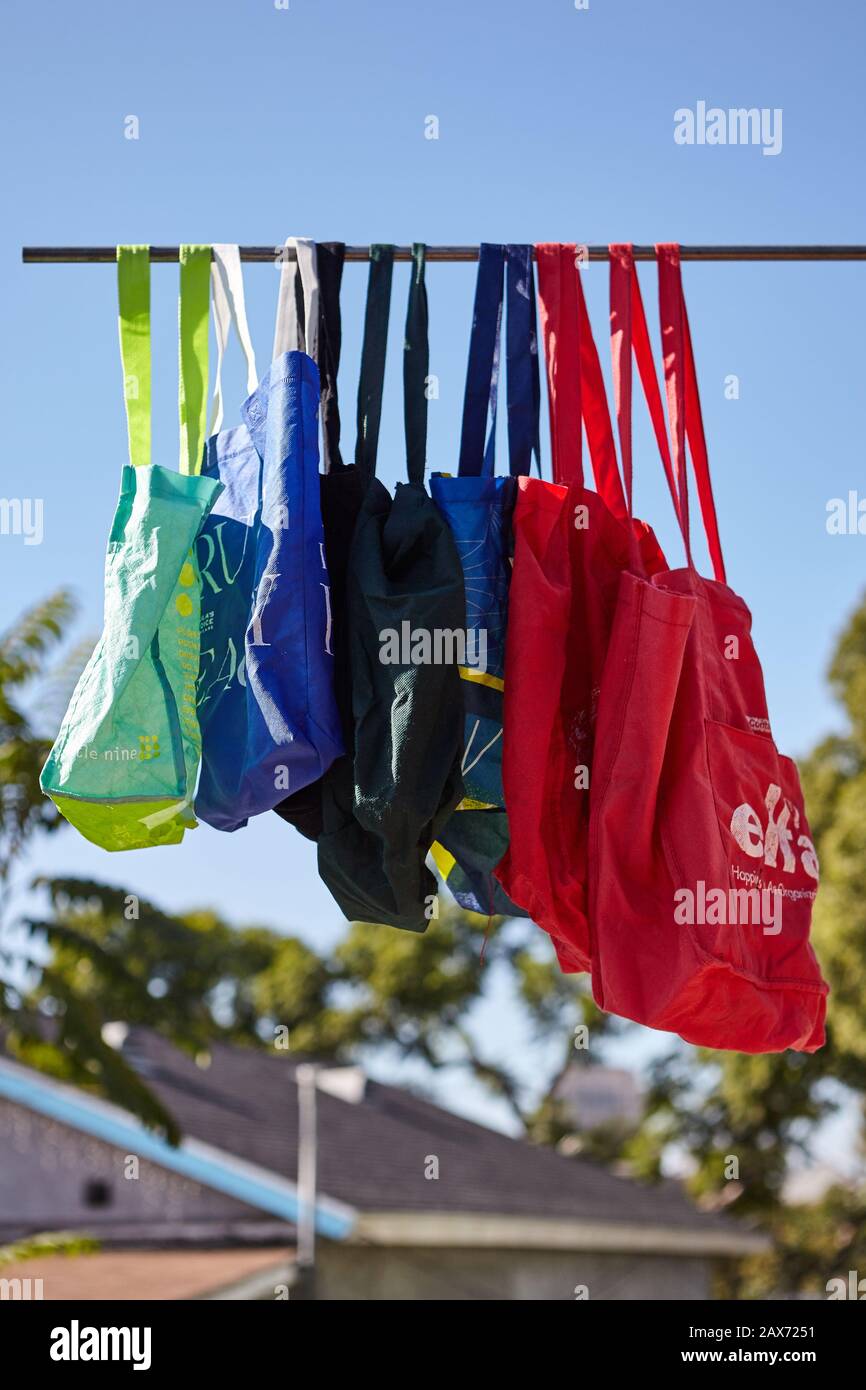 Low angle shot of colorful eco-friendly reusable cloth bags hanging on ...