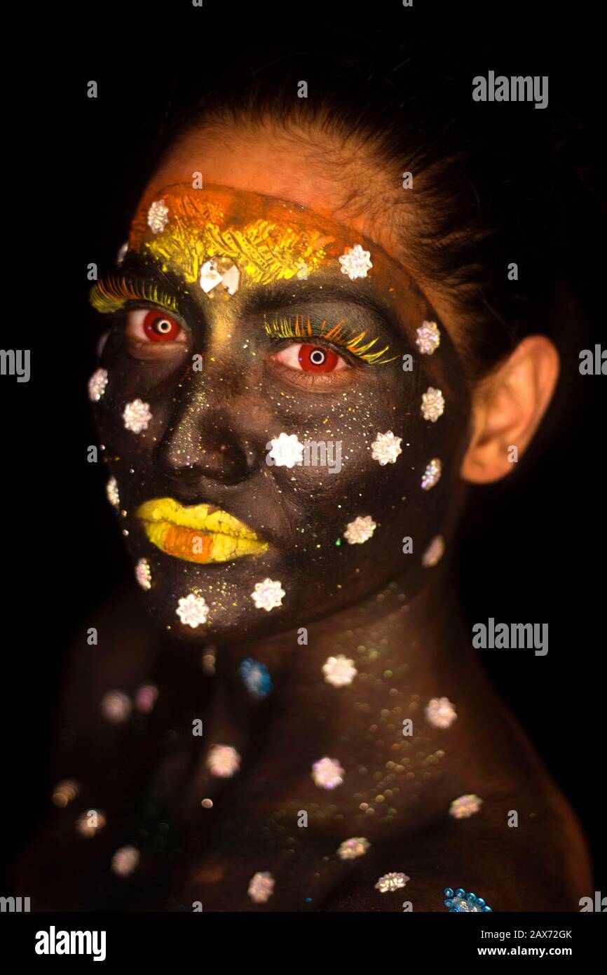 Fashion portrait of a dark-skinned girl with color make-up. Beauty face ...