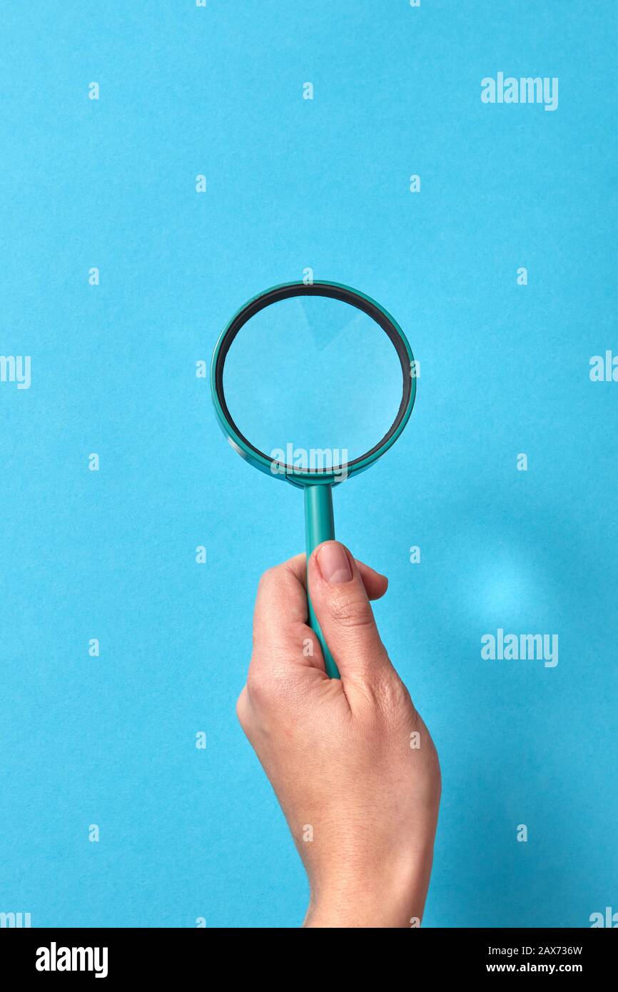 Loupe and hand hi-res stock photography and images - Alamy