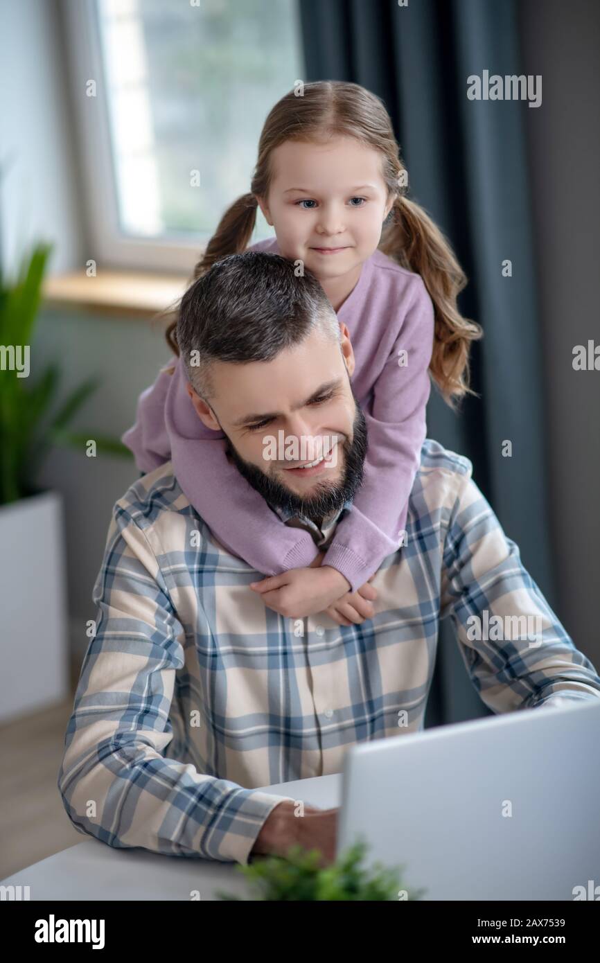 Joyful young dad, little daughter smiling looking at a laptop Stock ...