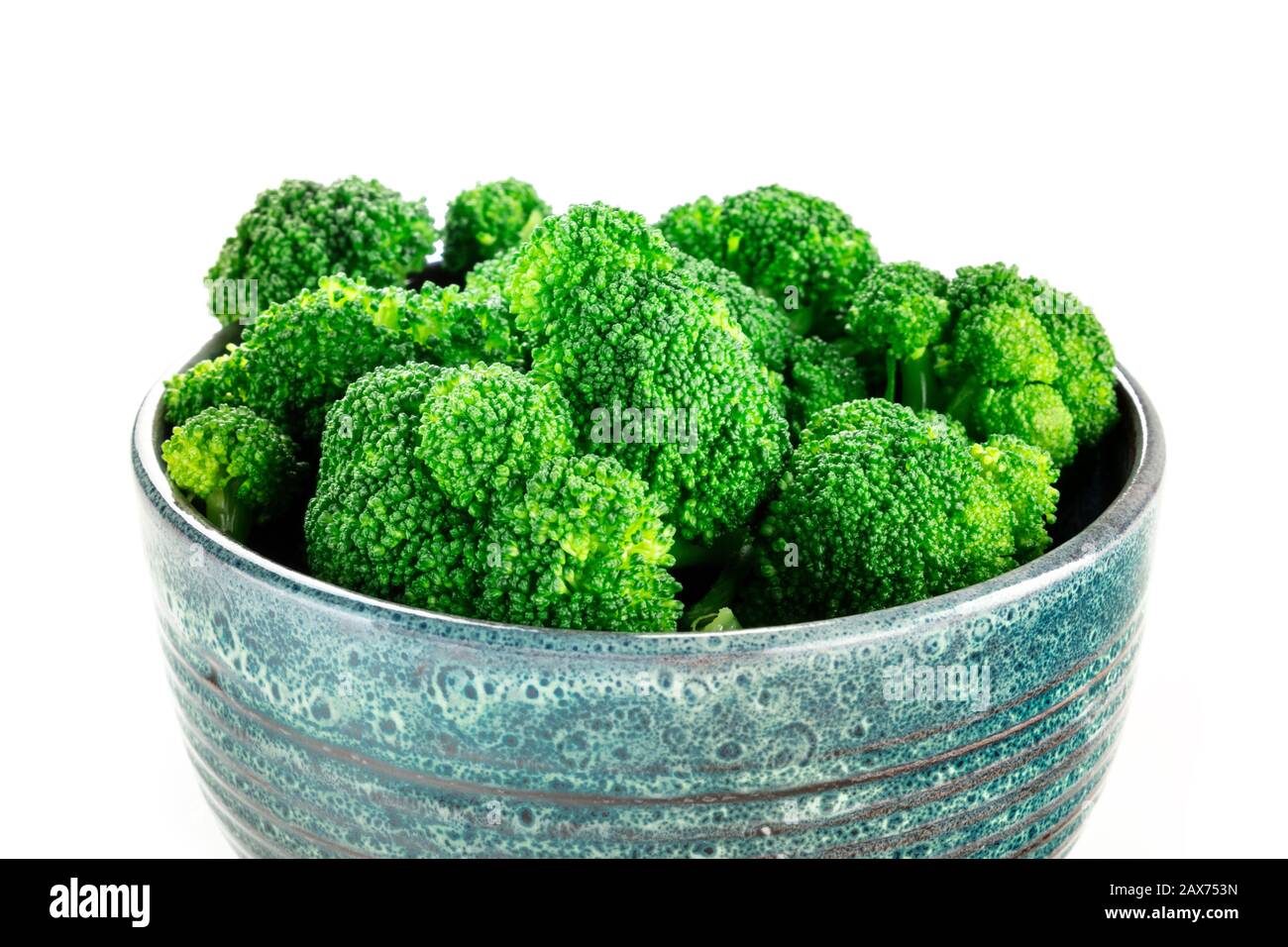 A bowl of cooked broccoli close-up on a white background Stock Photo ...