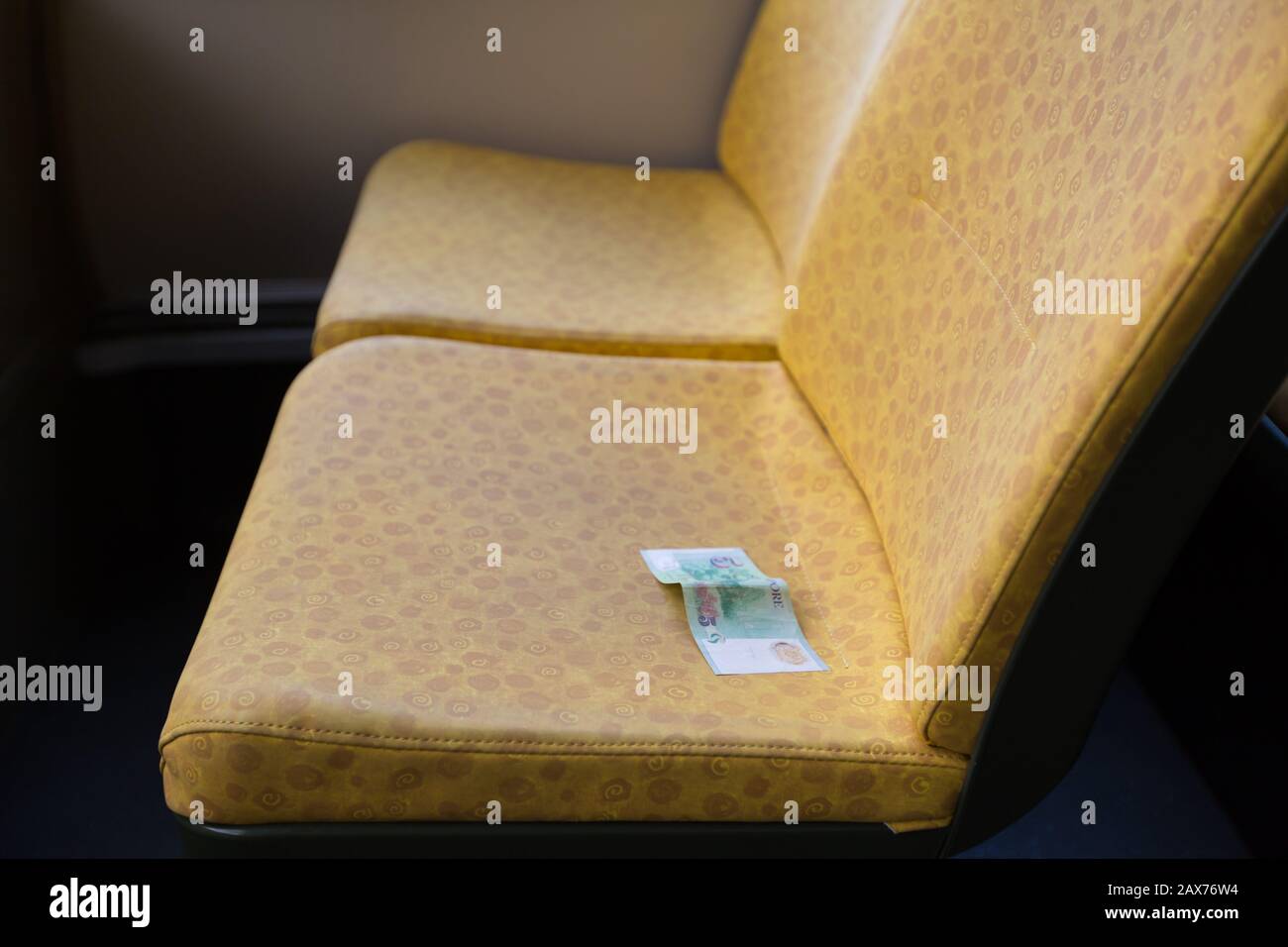 Finding money note on the yellow seat in a bus Stock Photo - Alamy