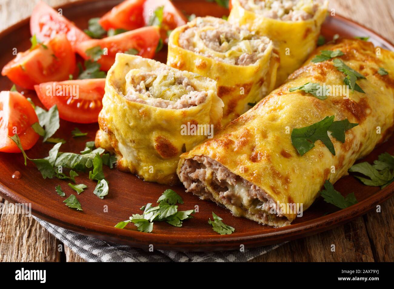 Russian food Brizol with meat, cheese and pickled cucumbers close-up in ...