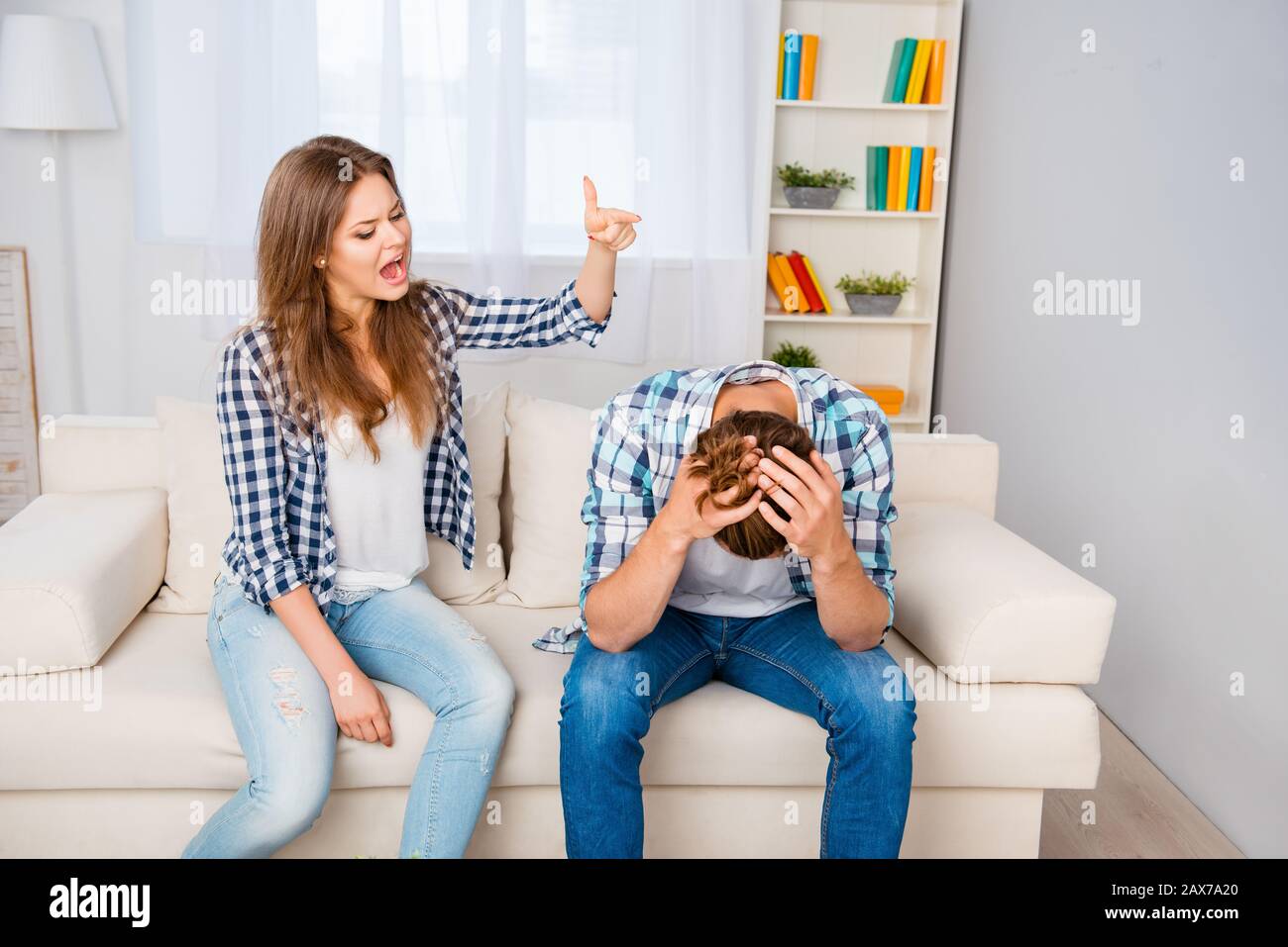 Portrait of angry woman screaming on her sad boyfriend Stock Photo - Alamy
