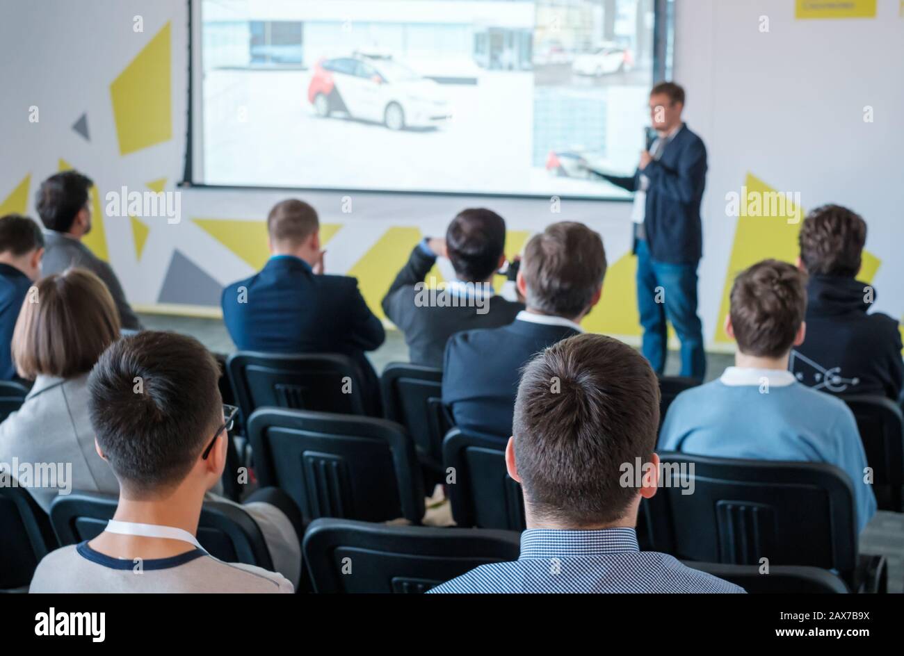Male speaker doing presentation for business audience Stock Photo - Alamy