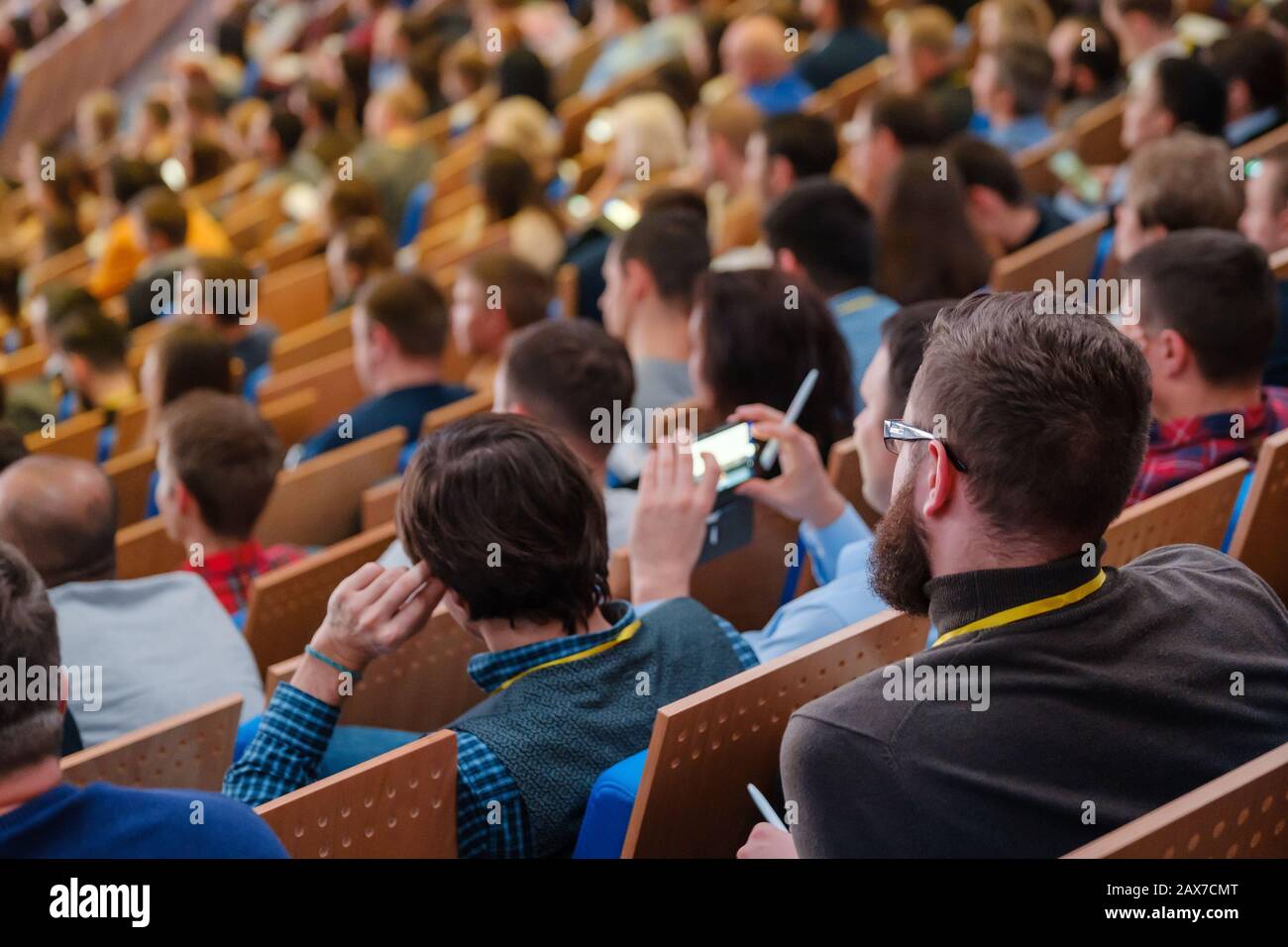 Business conference attendees sit and listen Stock Photo - Alamy