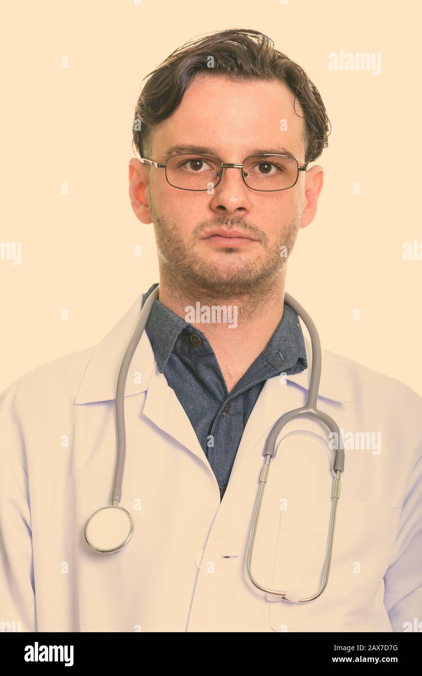 Face of young man doctor with eyeglasses Stock Photo - Alamy