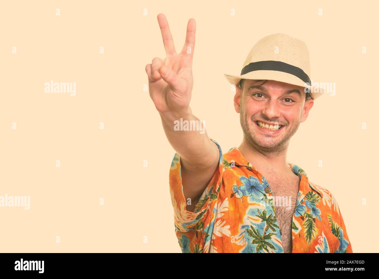 Young man giving peace sign hi-res stock photography and images - Alamy