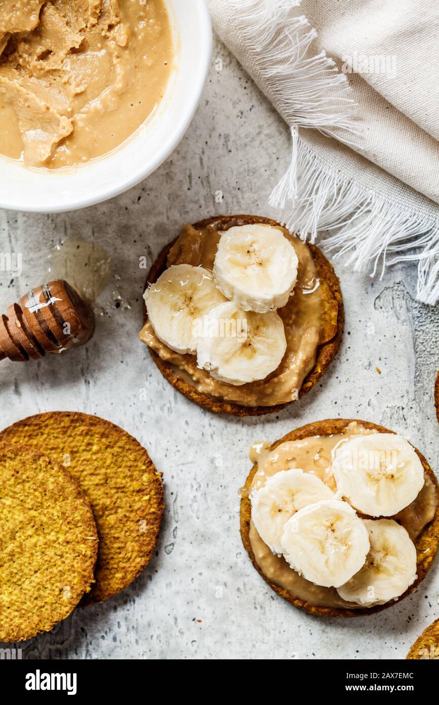 Peanut butter, banana and honey crackers. Vegan food concept Stock ...