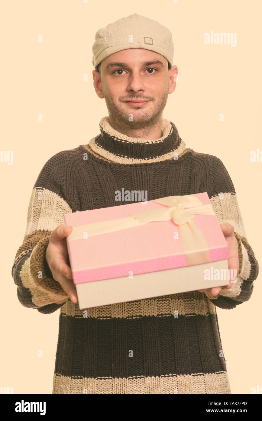 Young man giving gift box hi-res stock photography and images - Alamy