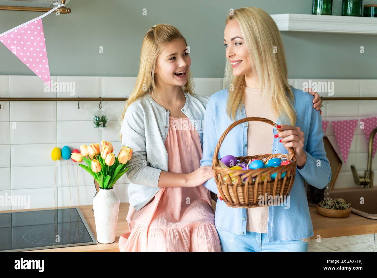 Easter concept, mom has an Easter basket and soap with her daughter ...