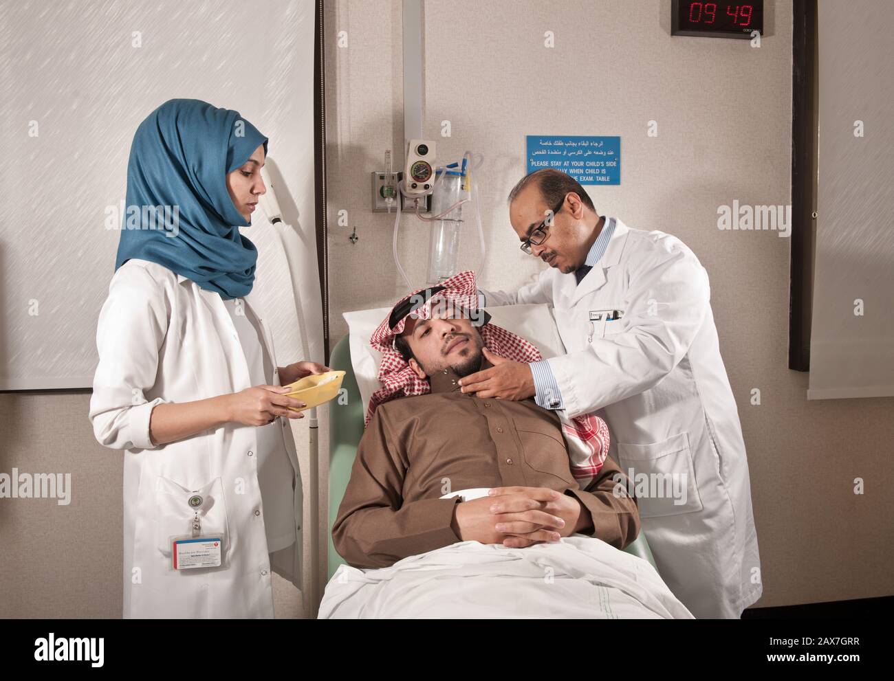 Doctor and nurse taking care of a patient in a hospital, Saudi Arabia ...