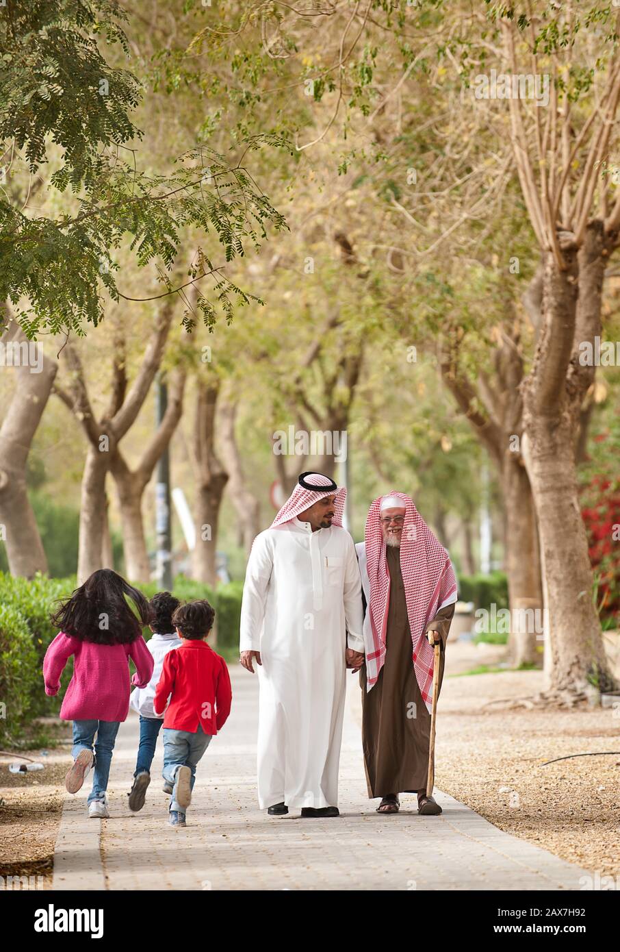 Elderly Saudi man walking with his son in Riyadh, Saudi Arabia Stock ...