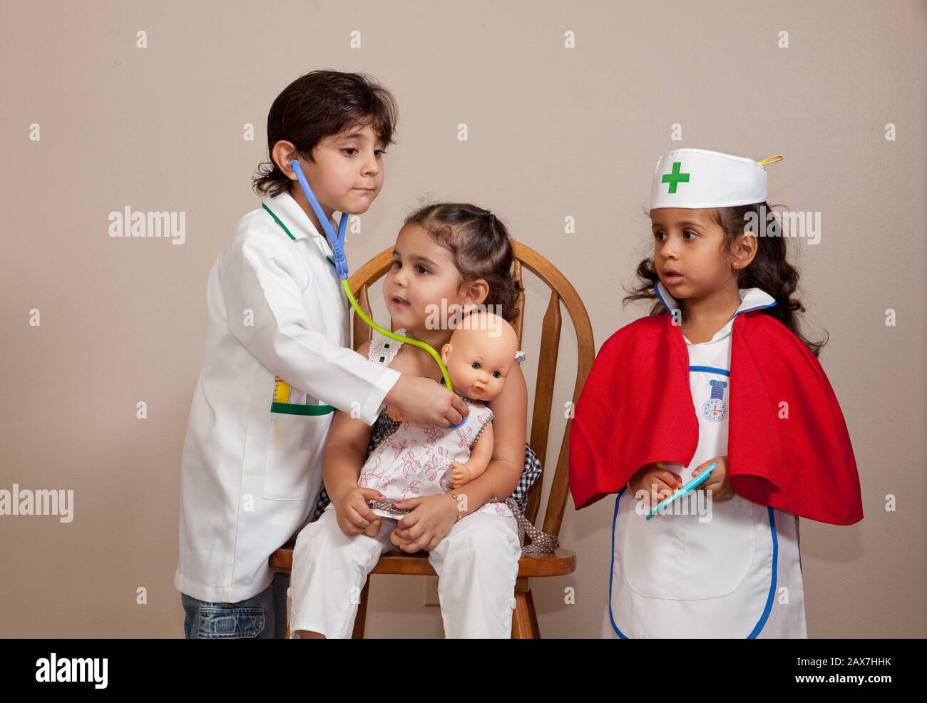 Children playing as a doctor, patient and nurse Stock Photo - Alamy