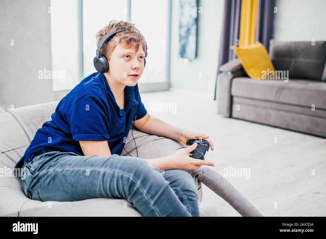 Gaming video games concept - teenage boy playing game with joystick and ...