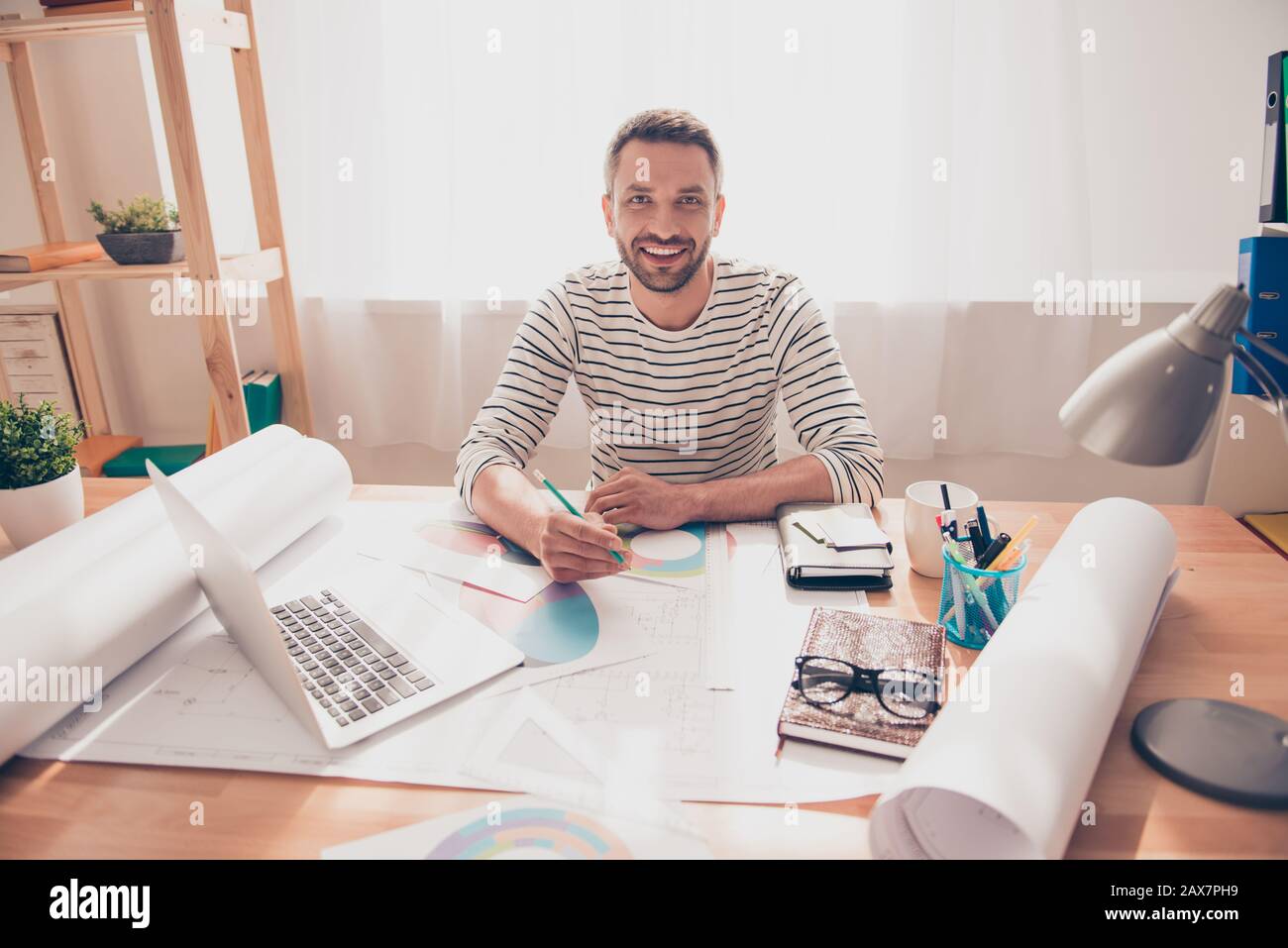 Happy smiling man drawing plan of building on blueprint Stock Photo - Alamy