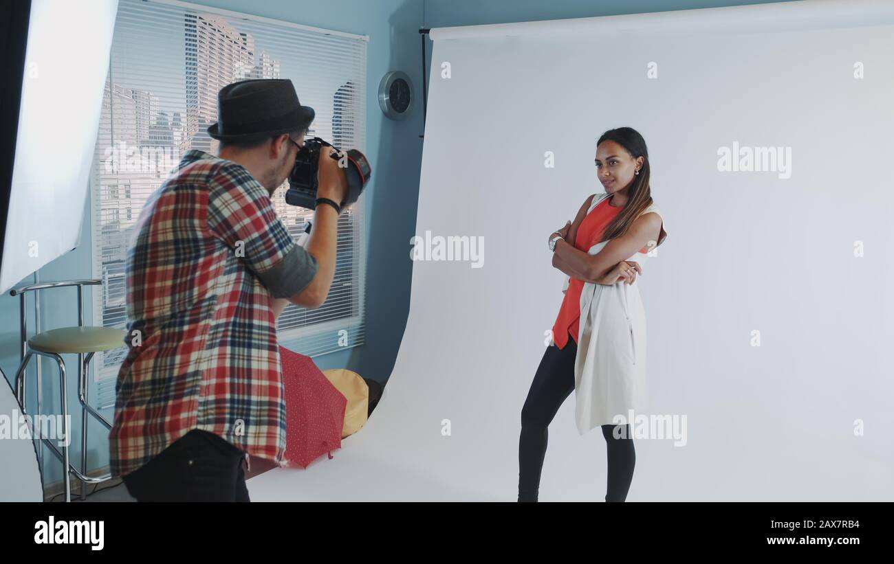 Behind the scenes on photo shoot: professional photographer working in ...