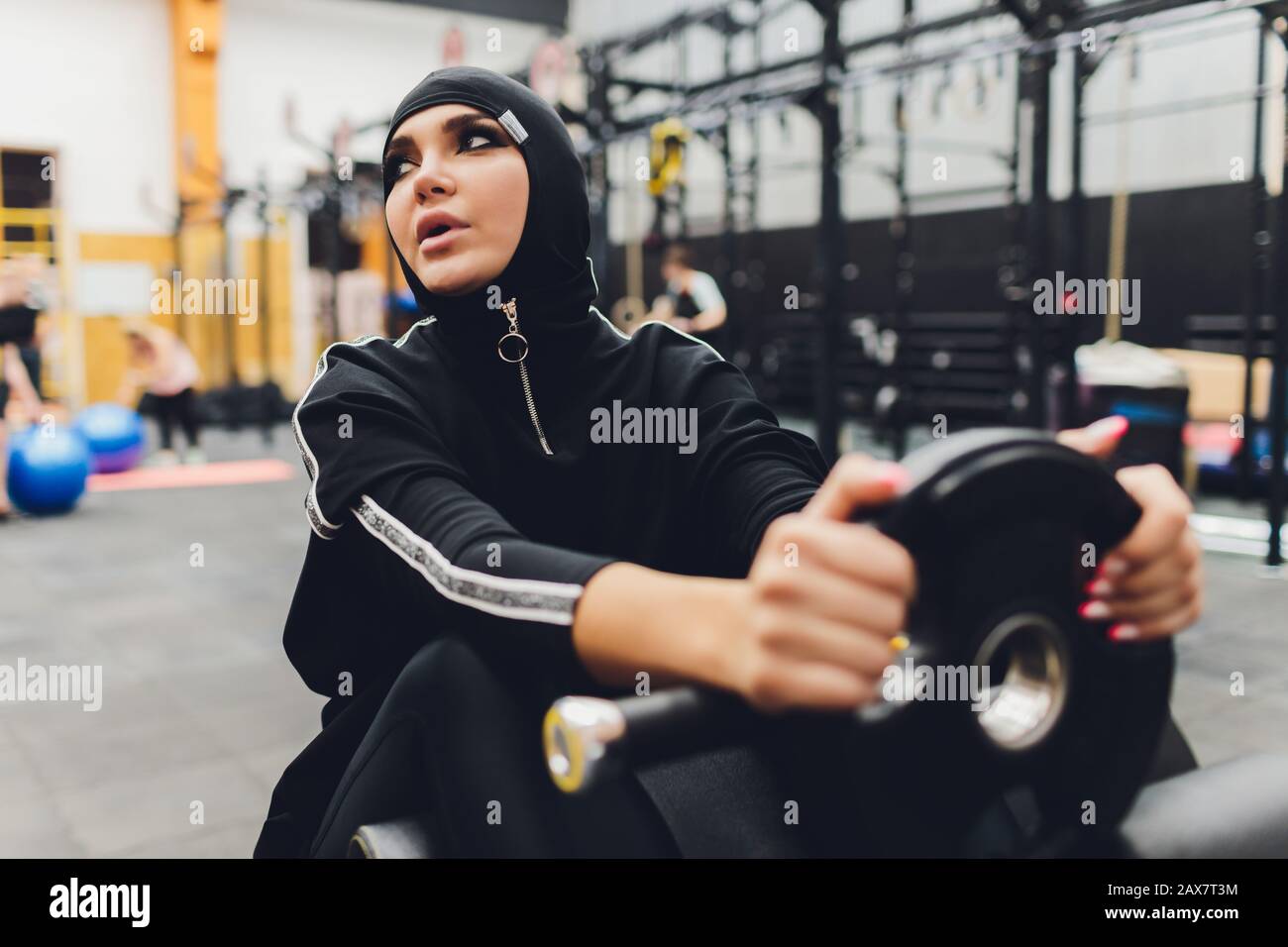 Muslim asian woman in hijab exercizing in a gym Stock Photo - Alamy