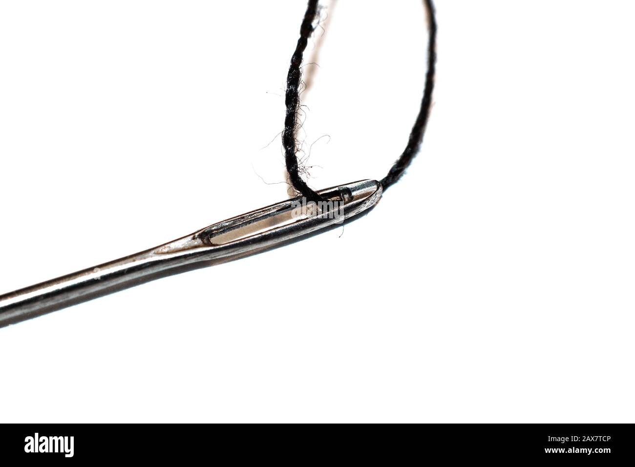 Ear of needle and black thread close up, macro photo Stock Photo - Alamy