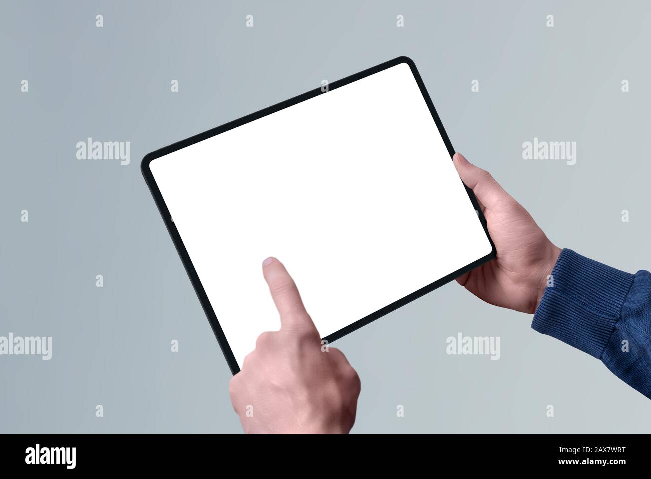 Tablet mockup in horizontal position in man hand. Left hand touch ...