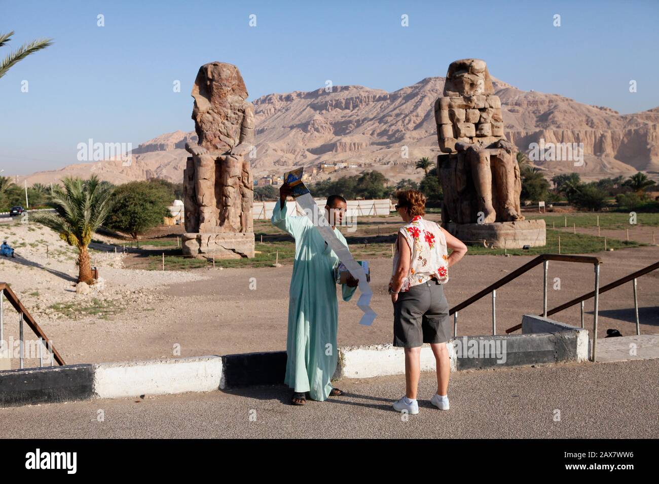 Luxor, Egypt, a man shows a woman a site map for sale Stock Photo - Alamy