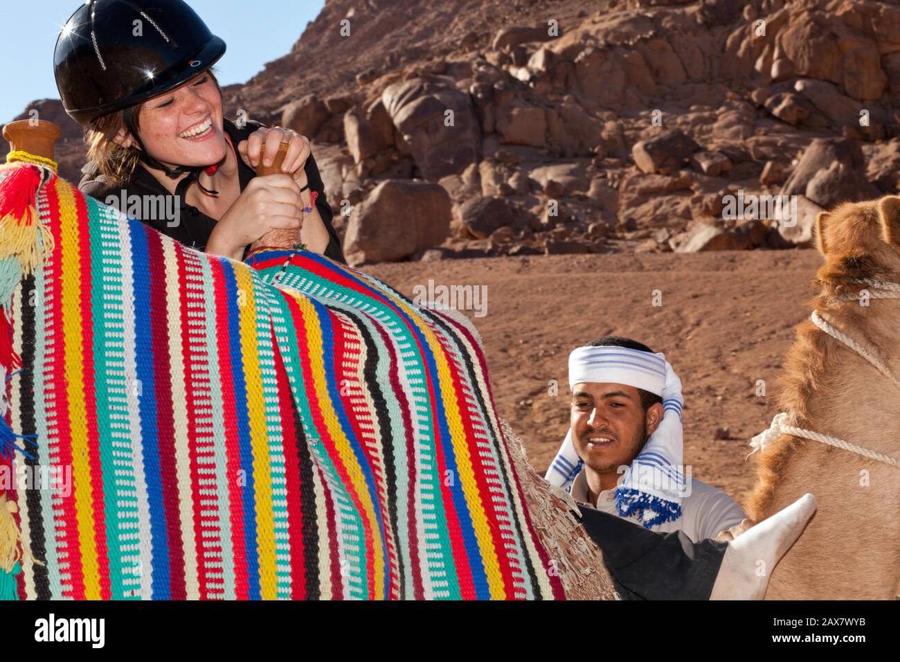 The writer, Lindsay Carroll attempts to mount the camel while it is ...